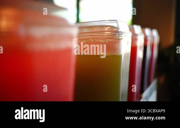 Colorful juice dispensers display fresh beverages with a focus on ...