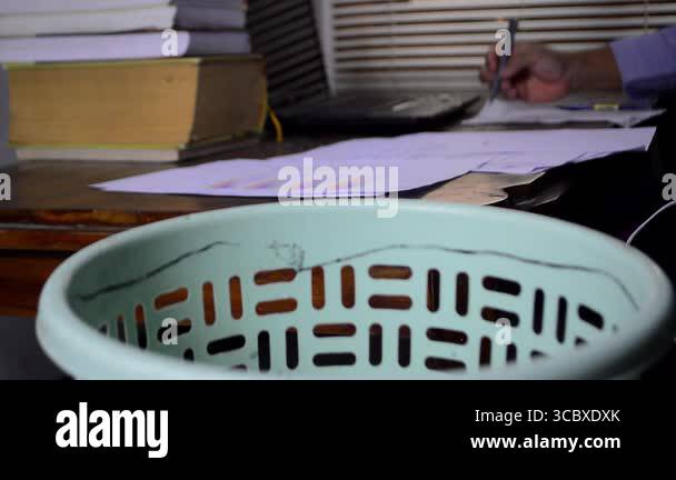 Frustration at work, Male office worker throwing crumpled paper into ...