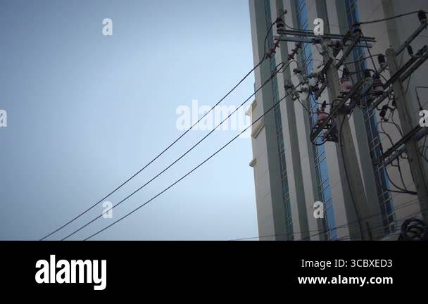 Highvoltage power lines intricately intersecting with modern urban ...