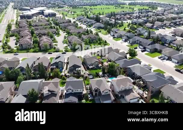 Residential neighborhood with many houses and cars. The houses are ...