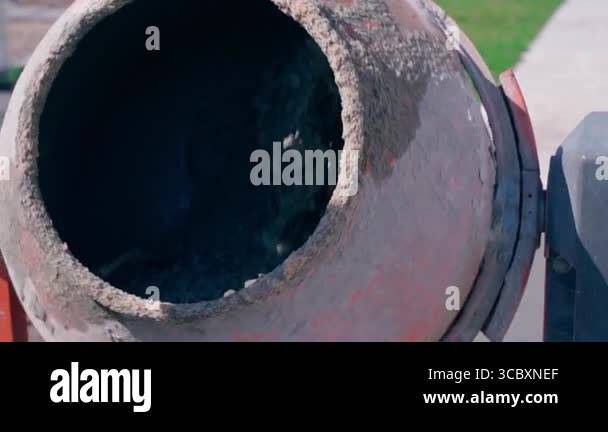 Slow motion shot of a concrete mixer working, close-up. Mixing concrete ...