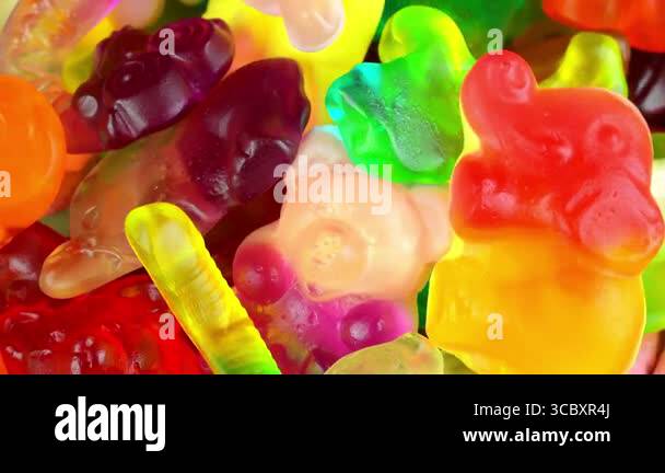 Gelatin sweets. Jelly candies on a rotating surface. Macro shot. The ...