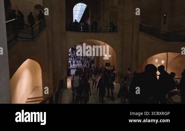 Visitors navigating the Louvre's busy staircase Stock Video Footage - Alamy