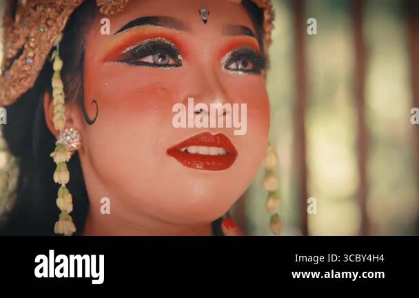 A stunning close-up of a female Javanese dancer's face. Her serene and ...