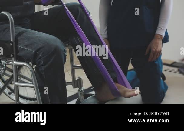 physiotherapist doing rehabilitation exercises with patient in ...