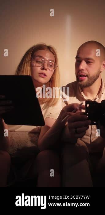 Vertical video. Discuss shooting. Team communicate. Group people sits compares results filming ...