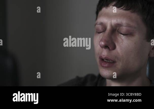 Emotions after breakup. Close-up of young man watching photos of his ex ...