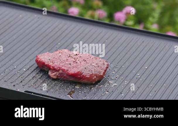 outdoor cooking. cook preparing fresh beef fillet mignon steak with ...