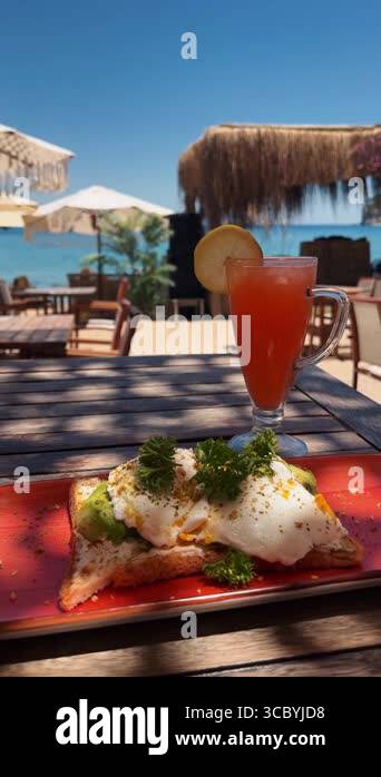 Delicious brunch featuring eggs and a refreshing drink while enjoying ...