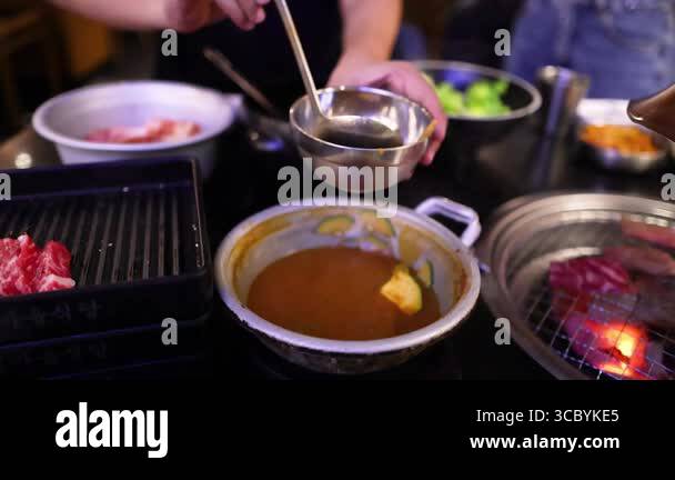 Ladling soup into a bowl at a restaurant Stock Video Footage - Alamy
