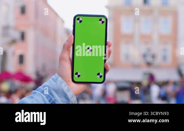 Woman using chroma key on smartphone in city centre. Female using ...