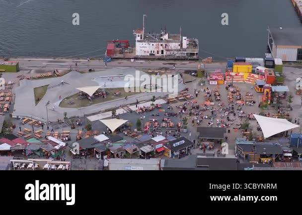 Aerial view of a bustling Copenhagen waterfront featuring a docked ship ...