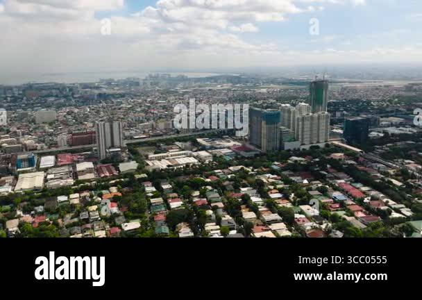 A mix of modern skyscrapers under blue skies in a vibrant urban setting ...