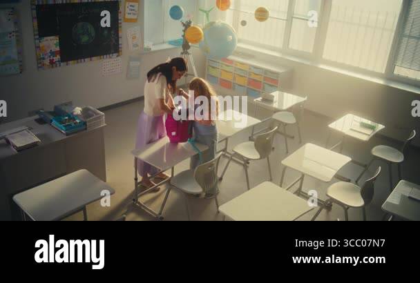 End of the School Day: Elementary School Girl Packing Her Backpack ...