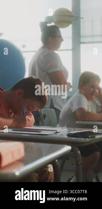 Elementary School Students Writing Exam or Doing Tasks in Notebooks ...