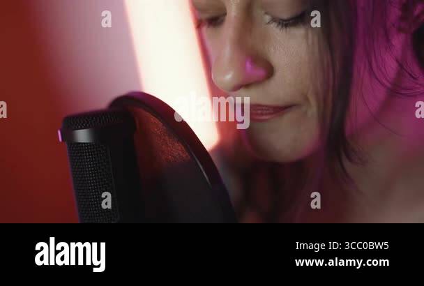 Female music producer in studio with audio recording equipment. Girl ...