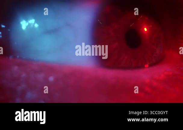 Macro shot of a real human eye with dramatic red and blue lighting. The ...