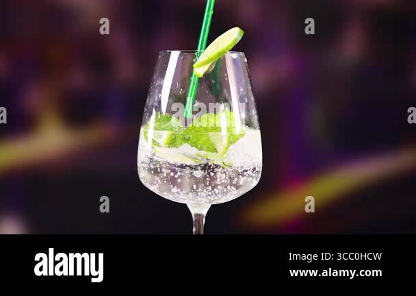 A sparkling mojito cocktail with lime and mint, set against a blurred ...