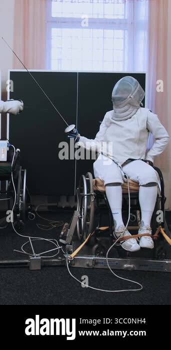 Disabled athlete. fencing. sparring in fencing duel of two wheelchair ...
