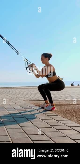 Workout outdoors. suspension straps. workout with straps. Athletic ...