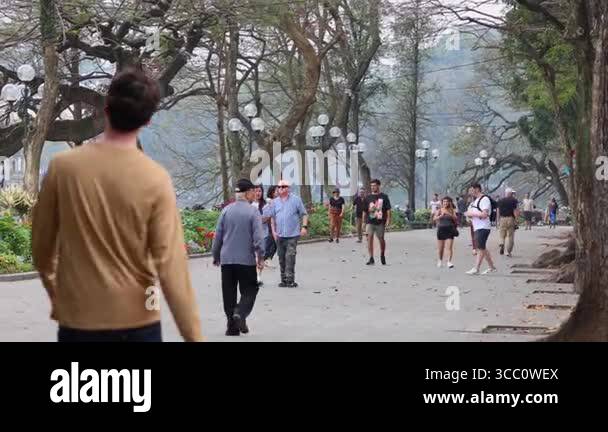 People enjoying a leisurely walk in the park Stock Video Footage - Alamy
