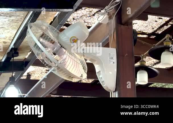 Rotating fan under wooden beams in Thailand Stock Video Footage - Alamy