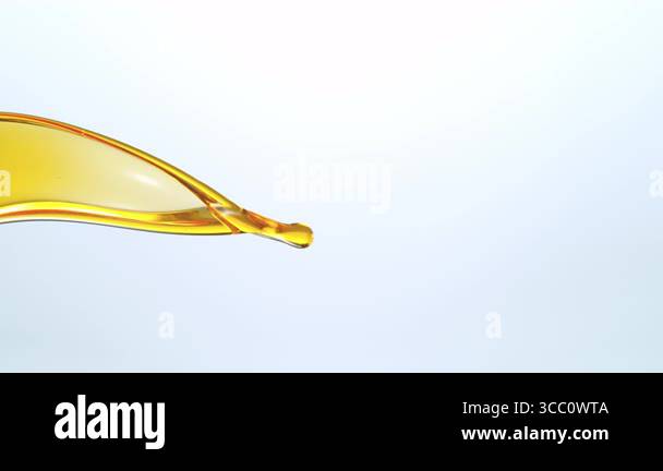 Super Slow Motion Shot of Waving Oil Splash on White Background at ...