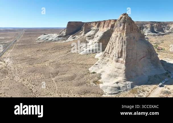 Aerial fly through over massive sandstone butte and cliffs near Page ...