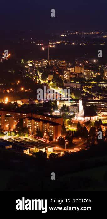 Vertical time lapse of a small city at night showing vibrant traffic ...