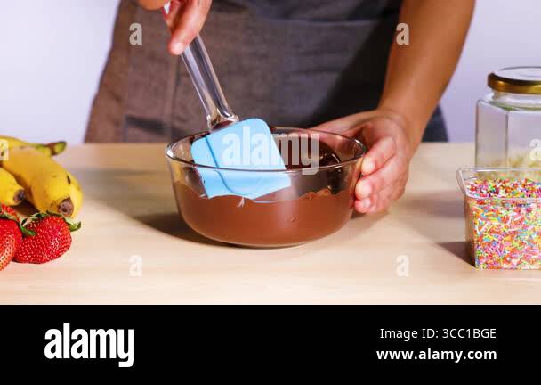 Mixing chocolate with spatula, fruits, and sprinkles Stock Video ...