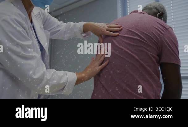 Doctor placing hands on patient back gliding down spine assessing ...