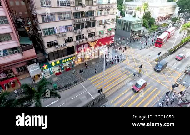 Traffic and pedestrians at a bustling intersection Stock Video Footage ...