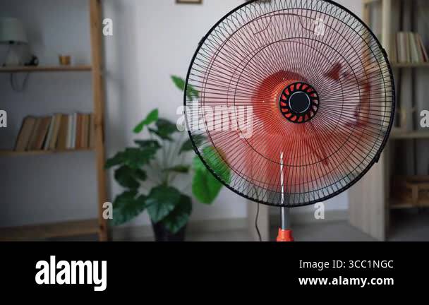 Working electric fan in hot room. Electric air Ventilator Cooling ...
