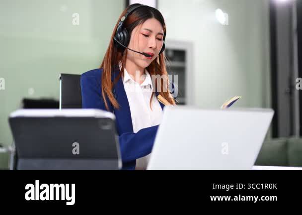 Female call center operator in wireless headset while talking with ...