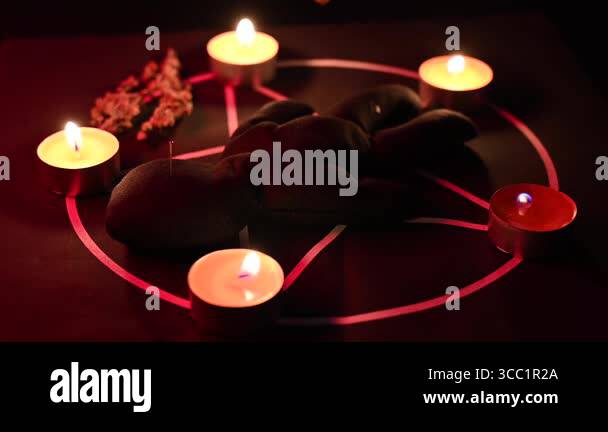 Woman sticking pins into voodoo doll Stock Video Footage - Alamy