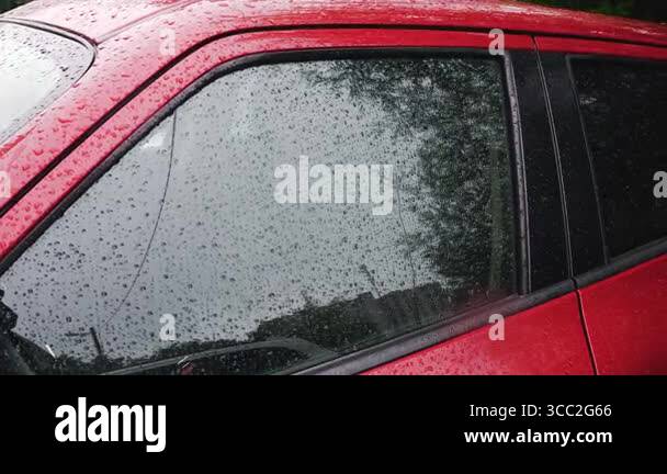 Water drops during rain roll down the side window of a car Stock Video ...