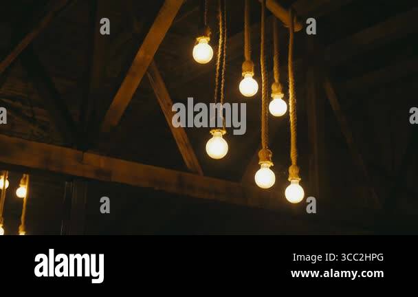 The warm glow emitted by the hanging lightbulbs beautifully evokes a ...
