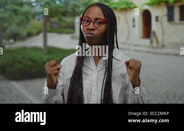 Woman outdoors expressing frustration on a cobblestone street, with red ...
