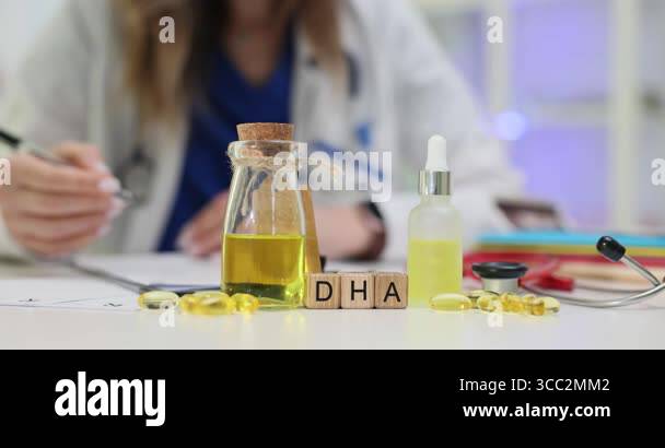 DHA written on cubes stands by supplements and oil in transparent jar ...