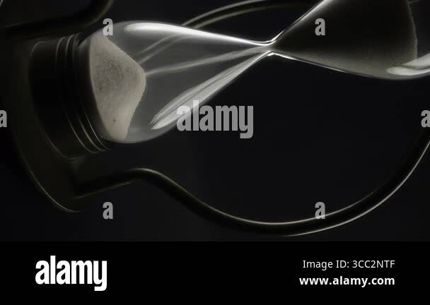 Abstract shot of vintage hourglass rotating on black background Stock ...
