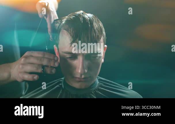 Young Man at Barber Shop. Barber is Preparing his Haircut. Dark ...
