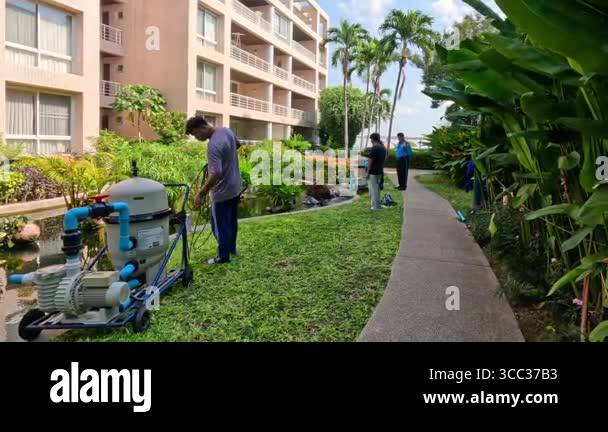 Workers tending to resort landscaping with equipment Stock Video ...