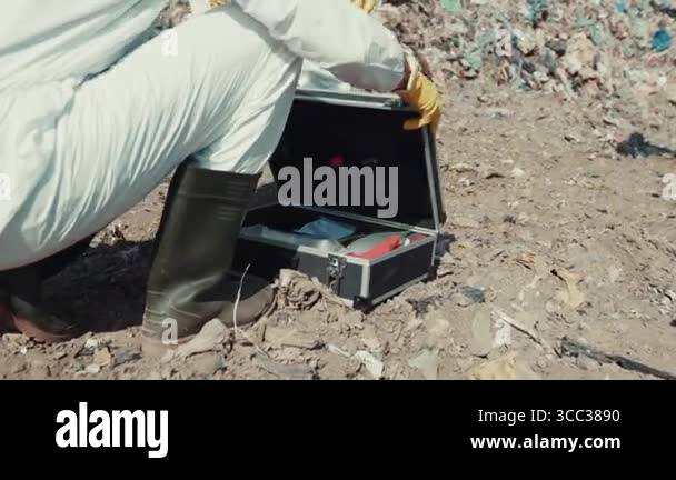 A dedicated researcher carefully examines various tools within a ...