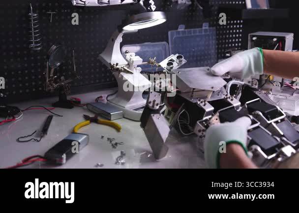 Repair the robot on the workbench Stock Video Footage - Alamy