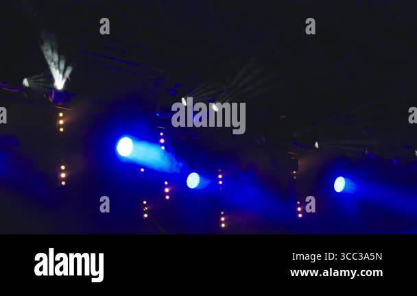 Stage with bright concert lighting, spotlights and smoke effects ...