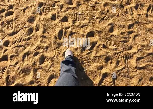 Footsteps in sand, beach huts, people walking Stock Video Footage - Alamy