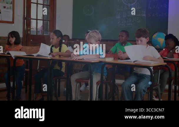 Students pausing pencil writing and raising hand after teacher cue ...