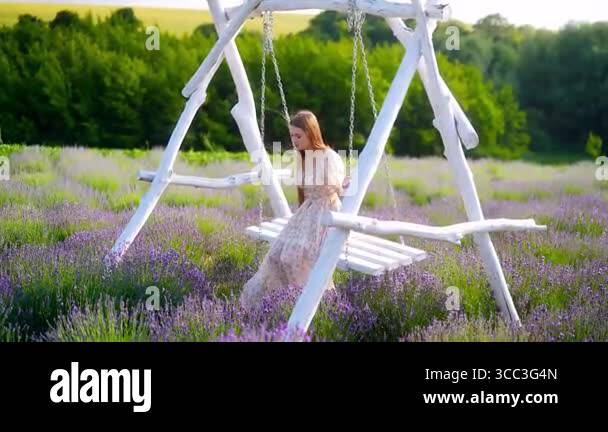 A young woman in a flowing purple dress walking gracefully through a ...