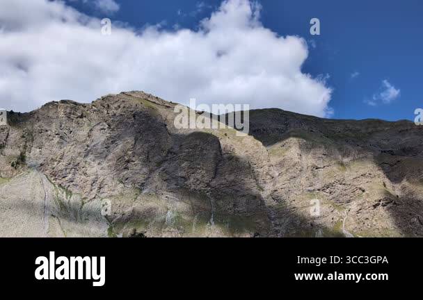 Coluds shadows scrolling on the face of a mountain in the French alps ...