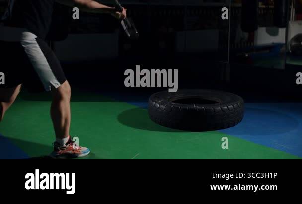 In a dim boxing ring, a determined man displays his skills in an ...